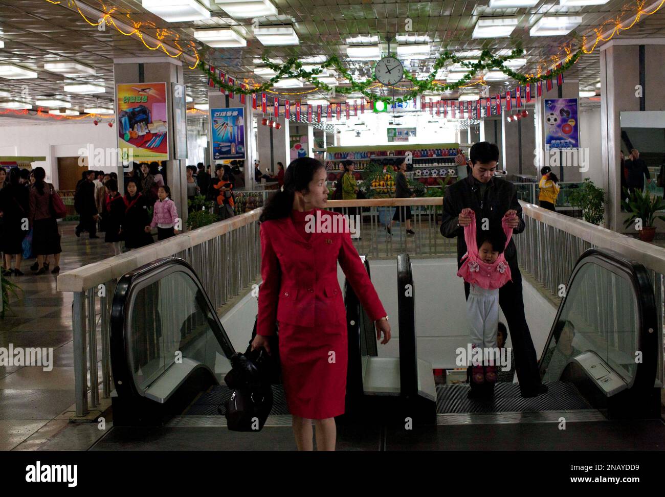 In this Sunday Oct. 9, 2011 photo, a North Korean man lifts his child ...