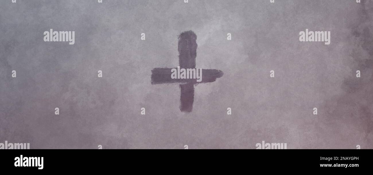 Cross made from ashes. Symbolic of Ash Wednesday. On vintage gray ...