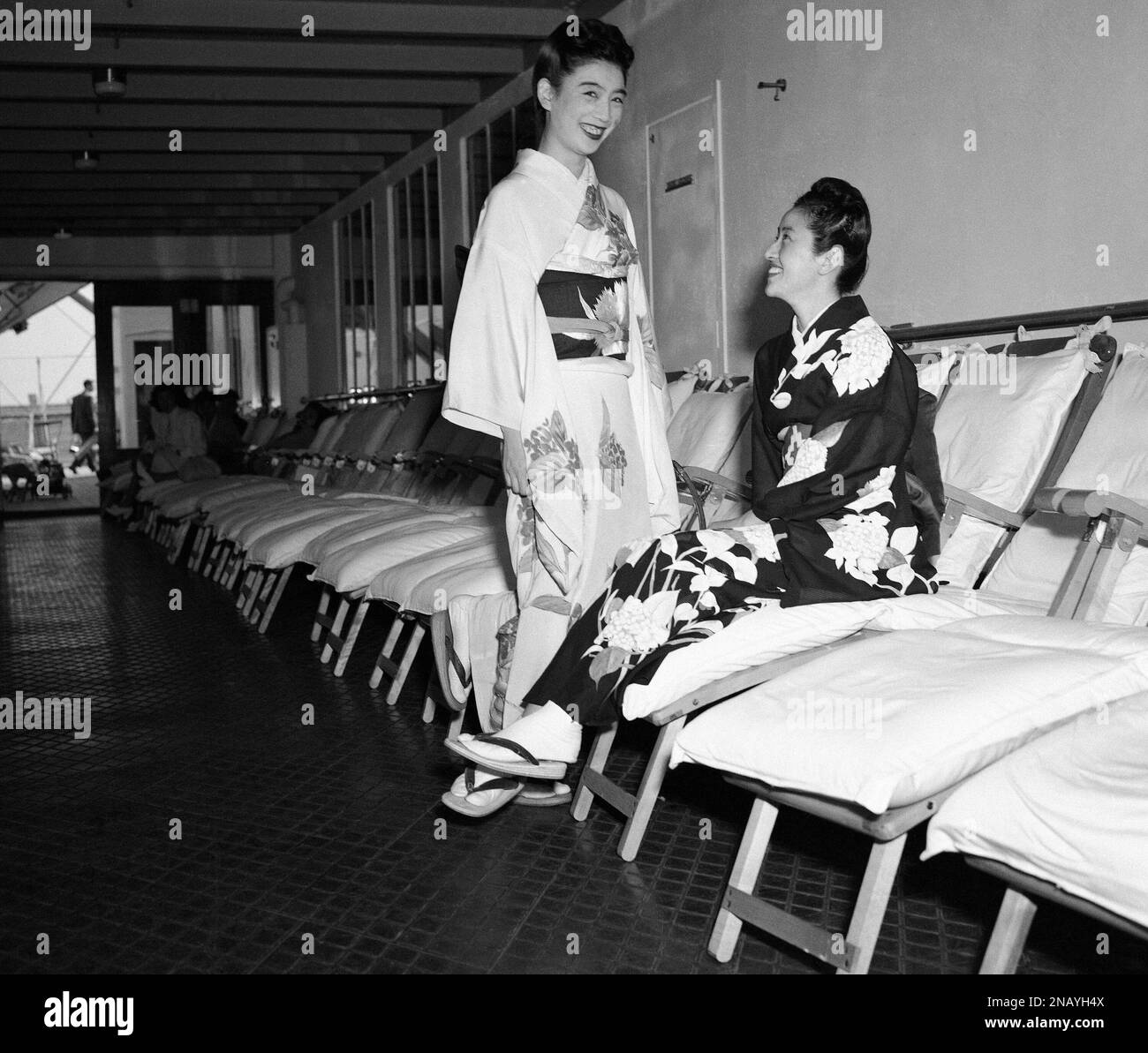 Two Japanese women try out the deck chairs on the SS President Wilson ...