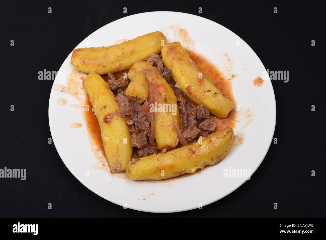 Beef stew served with matoke on an isolated background Stock Photo - Alamy