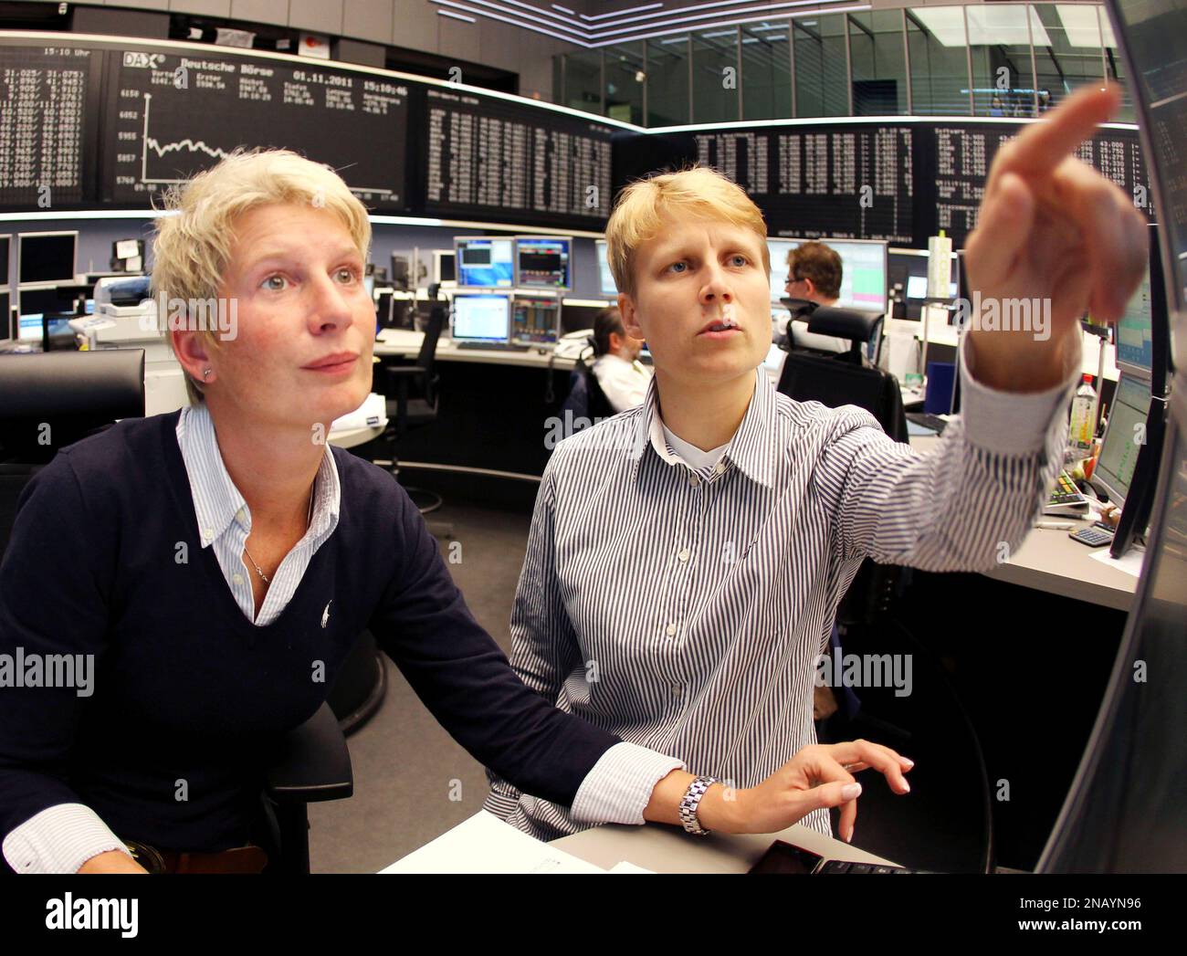 Traders watch their screens at the stock market in Frankfurt, Germany ...