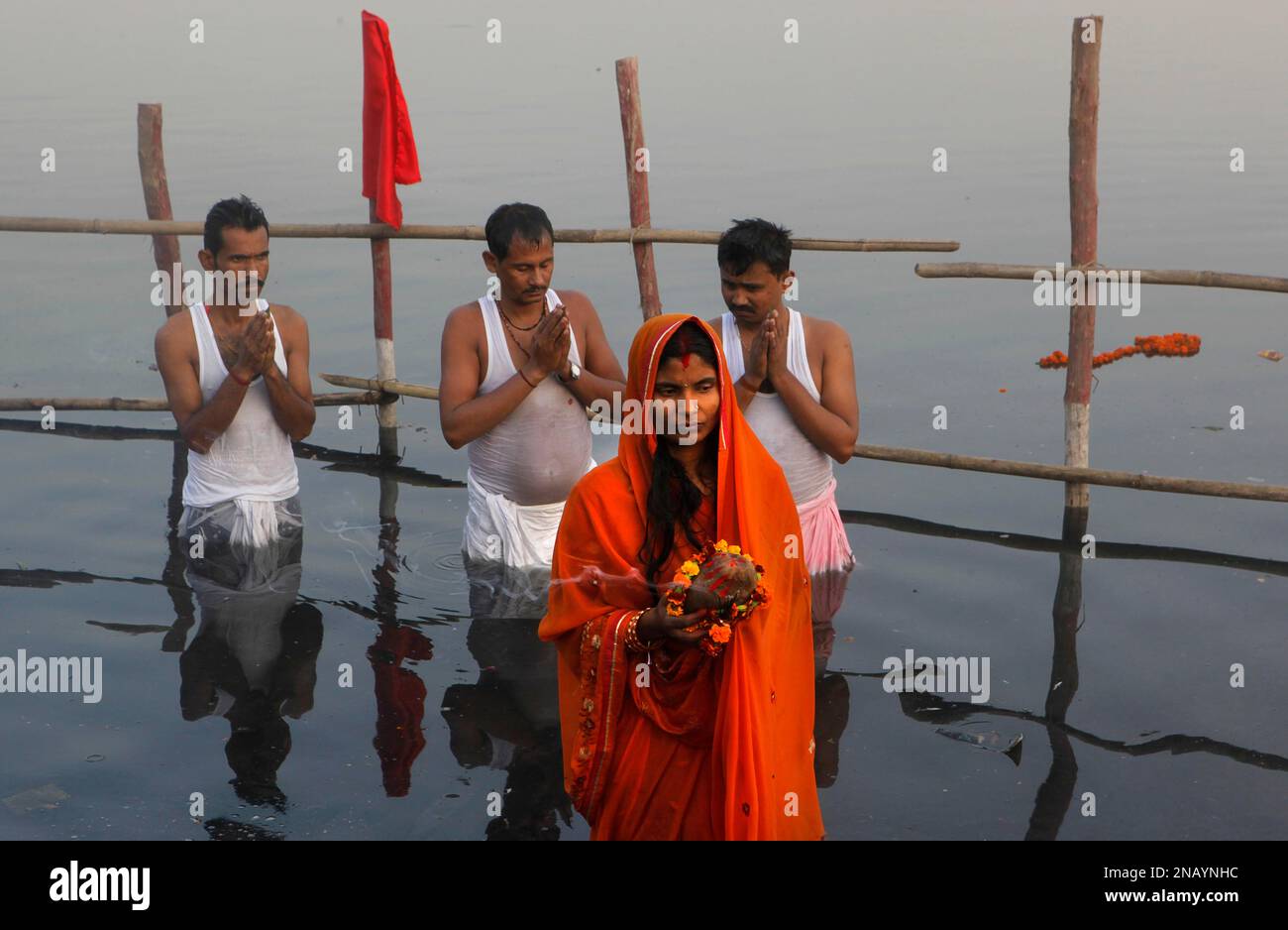 Hindu devotees perform rituals in River Yamuna at sunset during Chhath ...