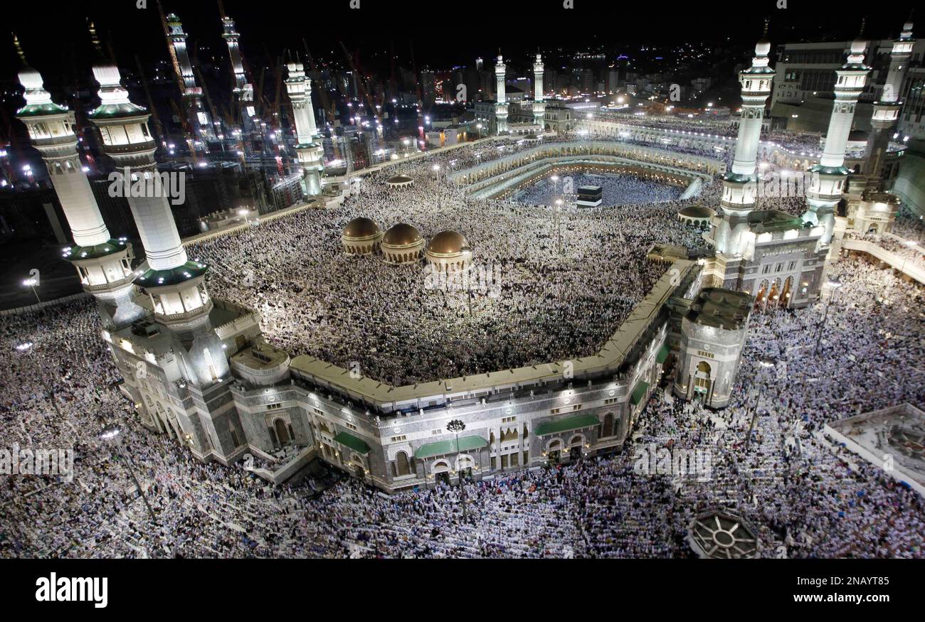Tens of thousands of Muslim pilgrims moving around the Kaaba, the black ...