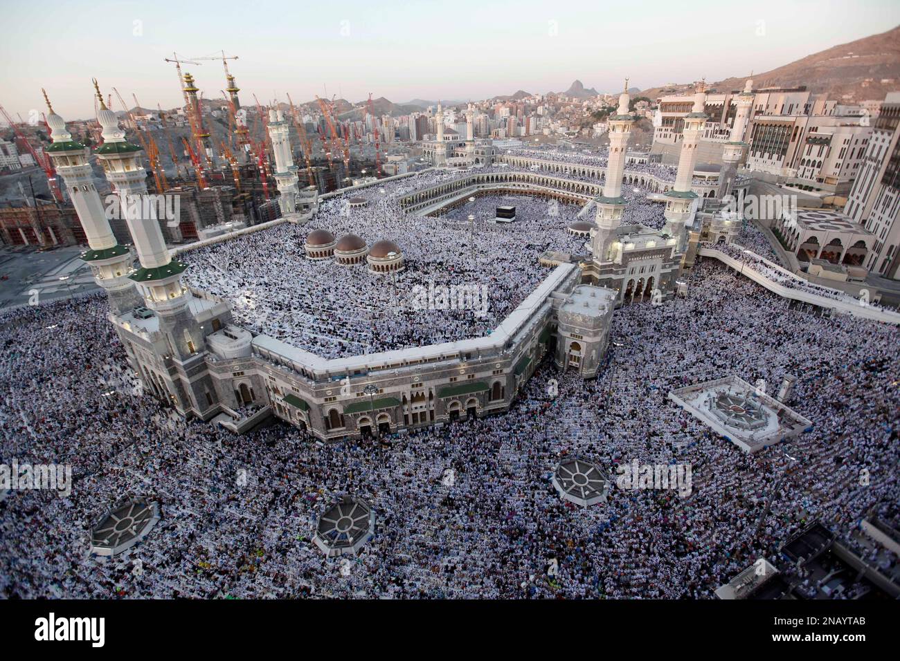 Tens of thousands of Muslim pilgrims moving around the Kaaba, the black ...