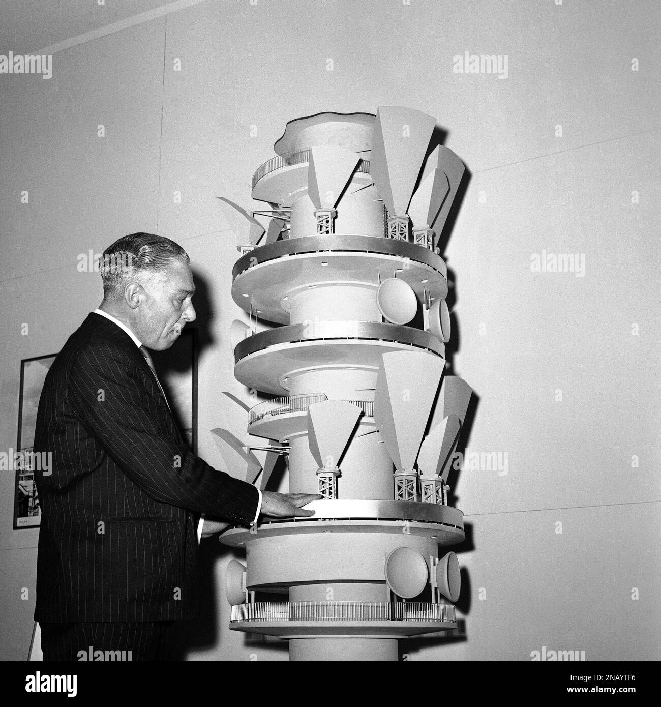 Reginald Bevins, the Postmaster General, inspects a model of a section ...