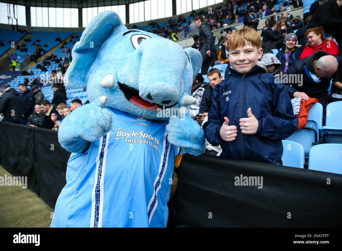 Coventry City mascot Sky Blue Sam poses for a photo with a fan at half ...