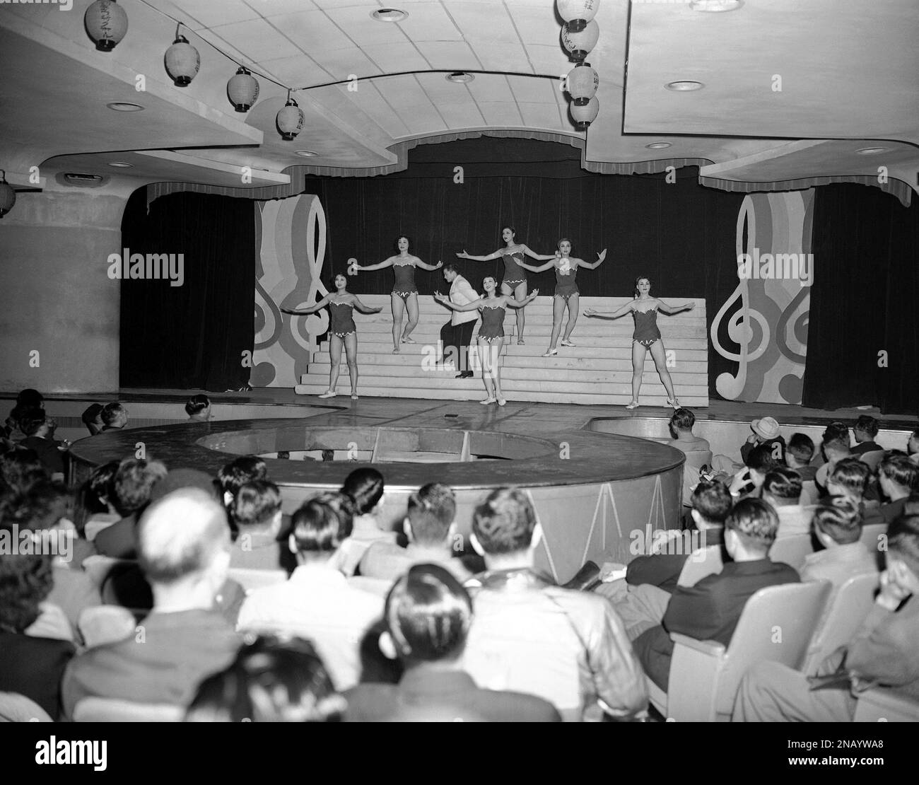 Tap dancer Yutaki Nitani performs on a staircase with chorus girls, at ...