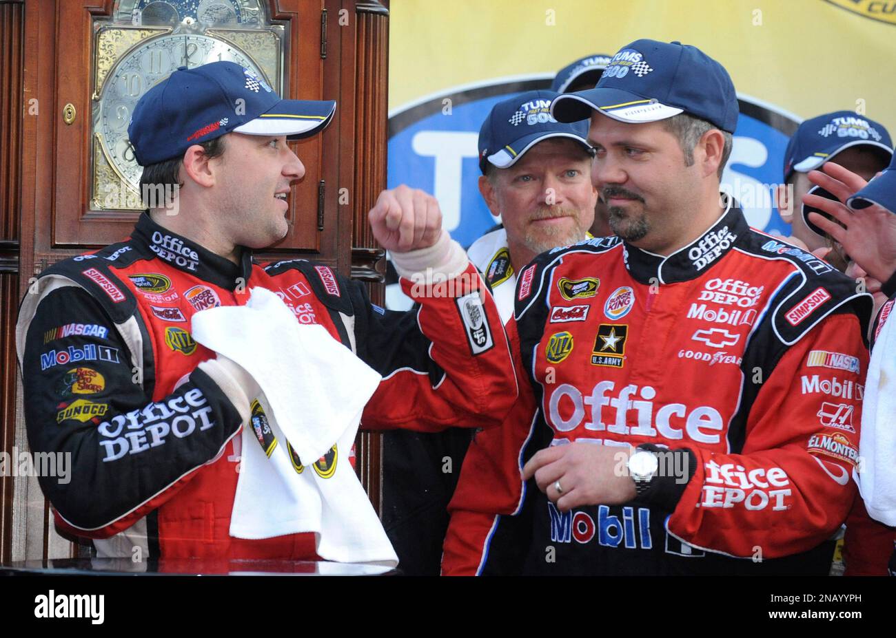 Tony Stewart talks with crew chief Darian Grubb, right, in victory lane ...