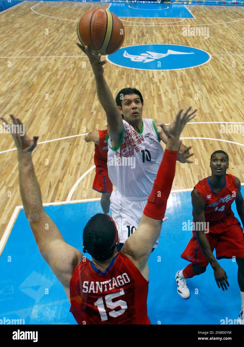 Mexico's Victor Mariscal, top, aims for the basket next to Puerto Rico ...