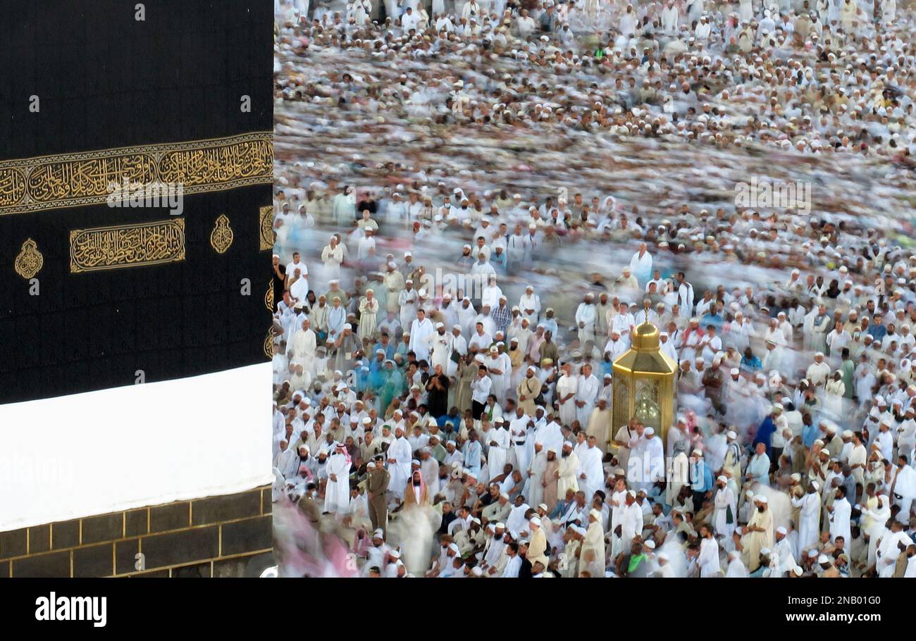 Tens of thousands of Muslim pilgrims moving around the Kaaba, the black ...