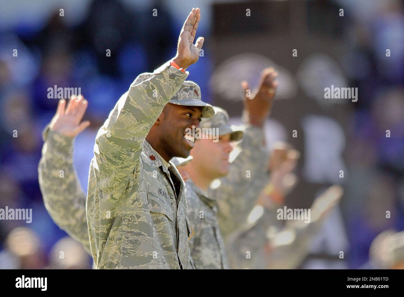 Members of the US military wave during pre game activities honoring ...
