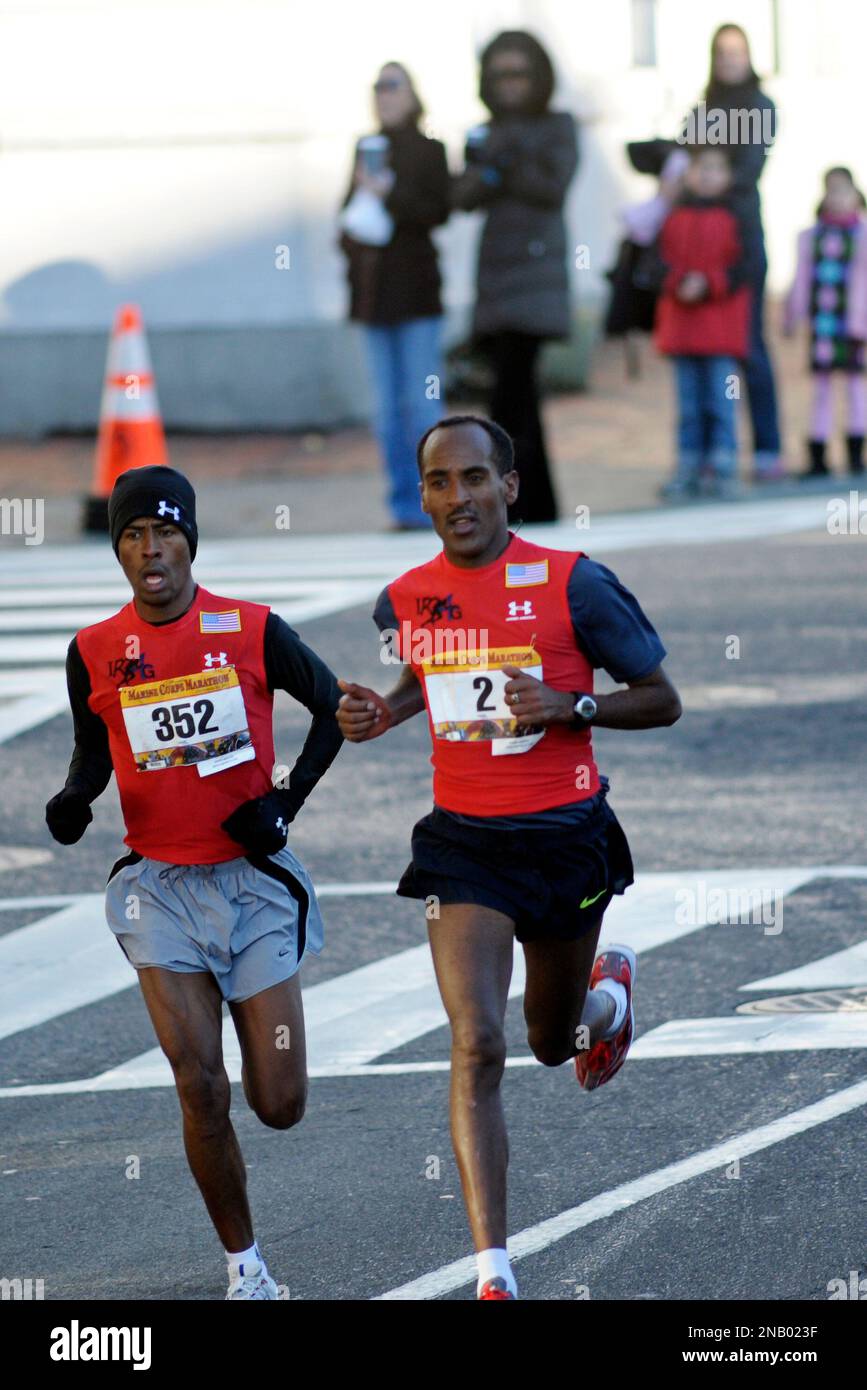 Ethiopian runners Temesgen Llanso, left, and Emeiry McKonnen are stride-for-stride as they pass ...