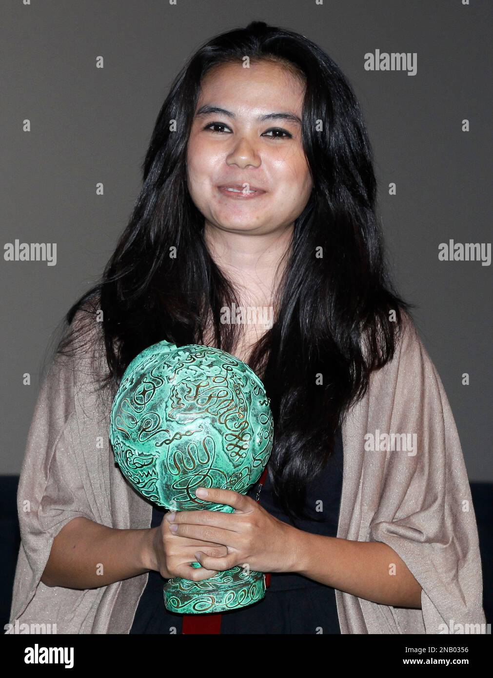 Film director Kamila Andini of Indonesia holds the trophy of the Toyota ...
