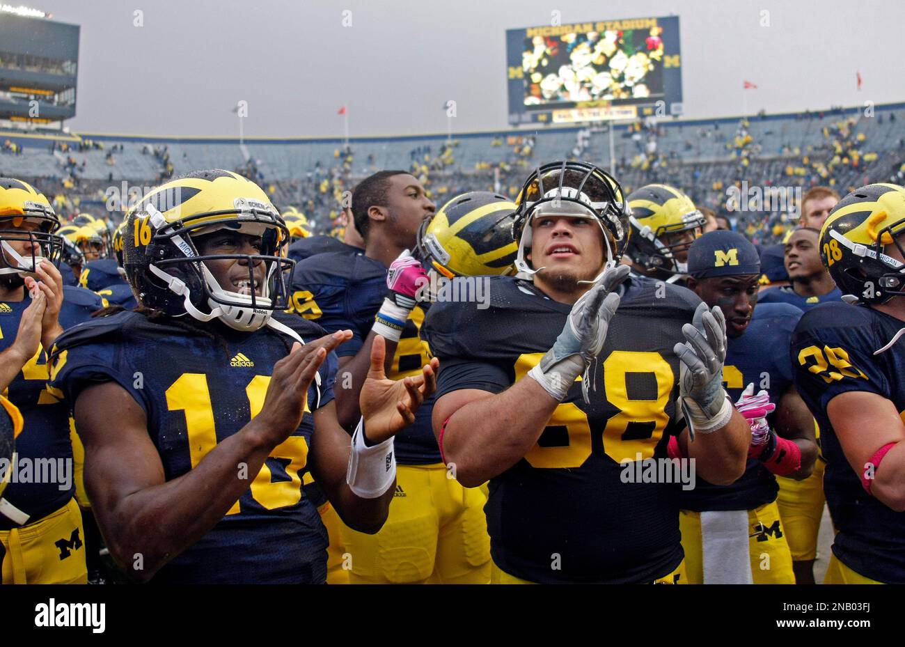 Michigan quarterback Denard Robinson (16) and defensive tackle Mike ...