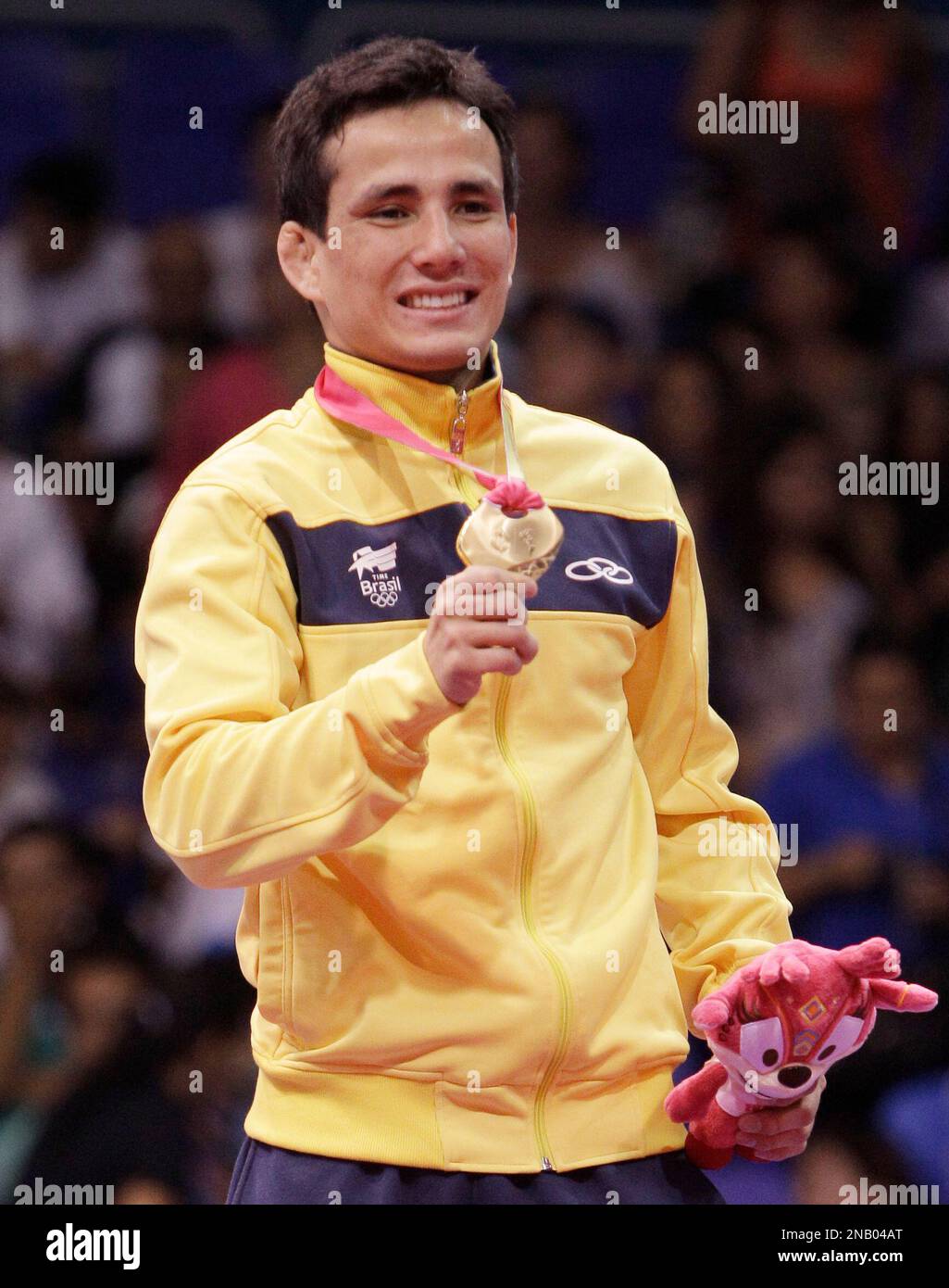 Gold medal Felipe Kitadai, of Brazil, celebrates on the podium during ...