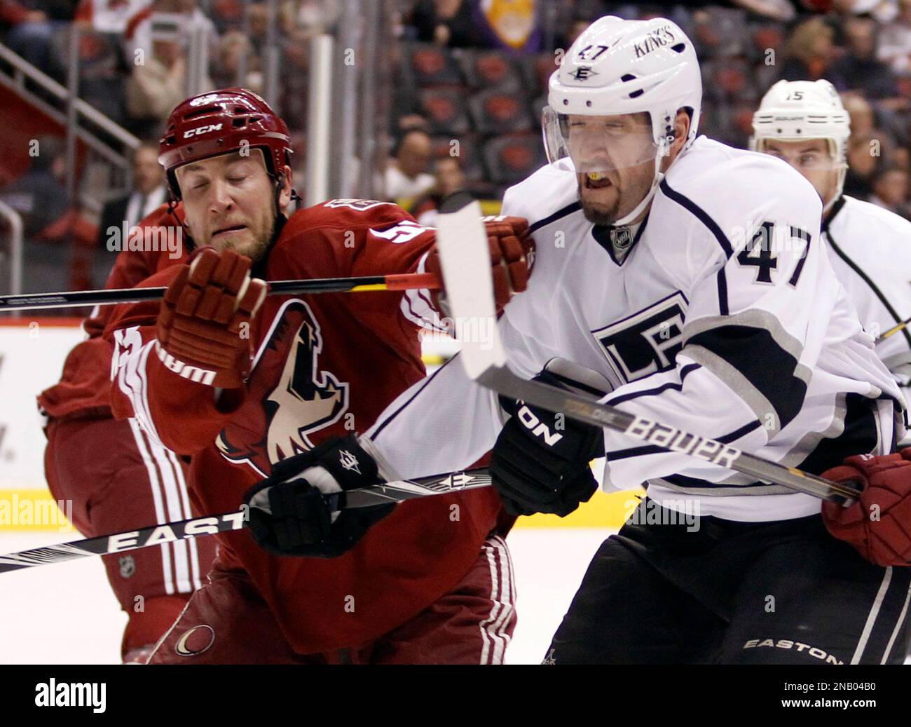 Phoenix Coyotes defenseman Derek Morris, left, checks Los Angeles Kings ...