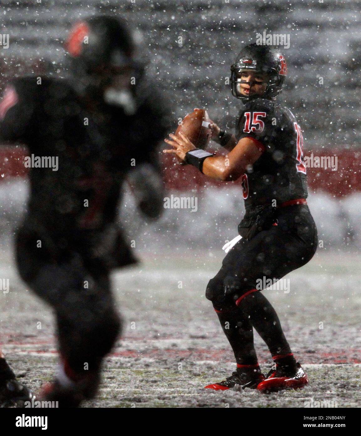 Rutgers quarterback Gary Nova (15) looks to throw a pass in the snow ...