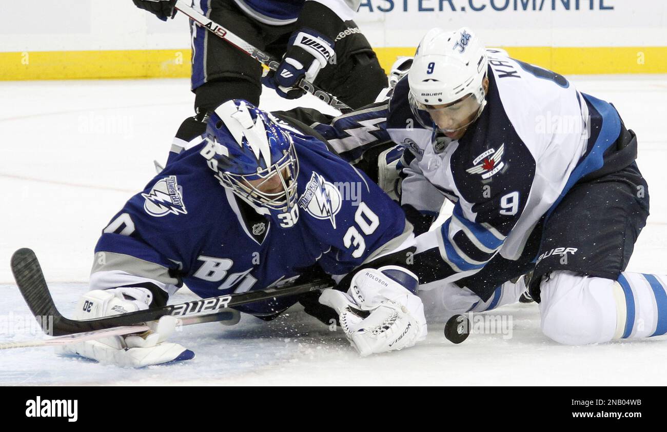 Tampa Bay Lightning goalie Dwayne Roloson (30) battles with Winnipeg ...