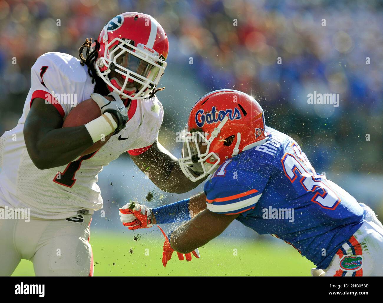 Georgia running back Isaiah Crowell (1) stiff arms Florida cornerback ...