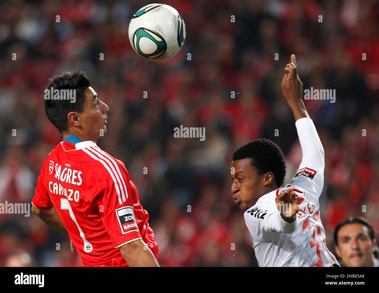 Benfica's Oscar Cardozo, left, from Paraguay, goes for a header with ...