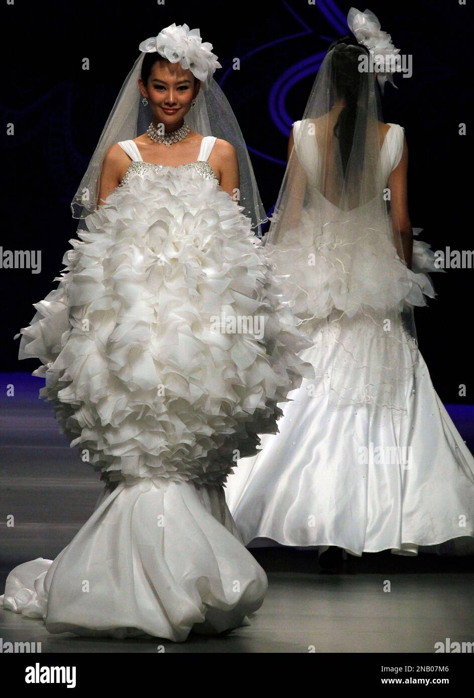 Models show off designs competing in the Famory Cup China Wedding Dress ...