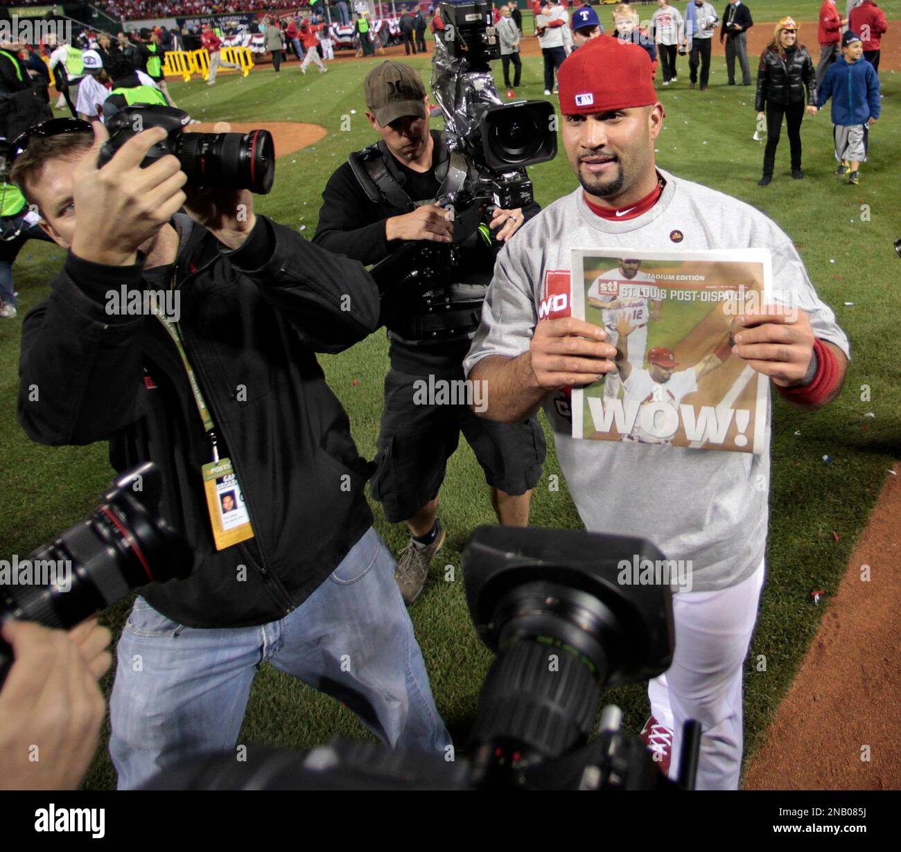 St. Louis Cardinals' Albert Pujols holds up a newspaper after Game 7 of ...