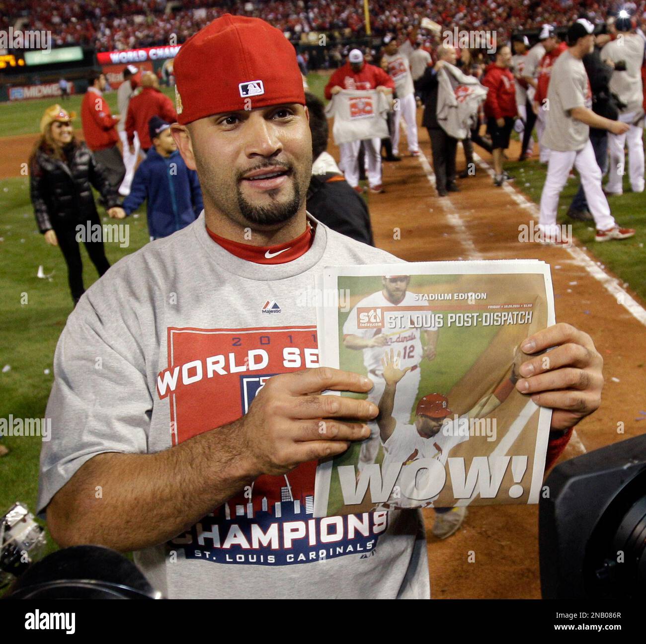 St. Louis Cardinals' Albert Pujols holds up a newspaper after Game 7 of ...