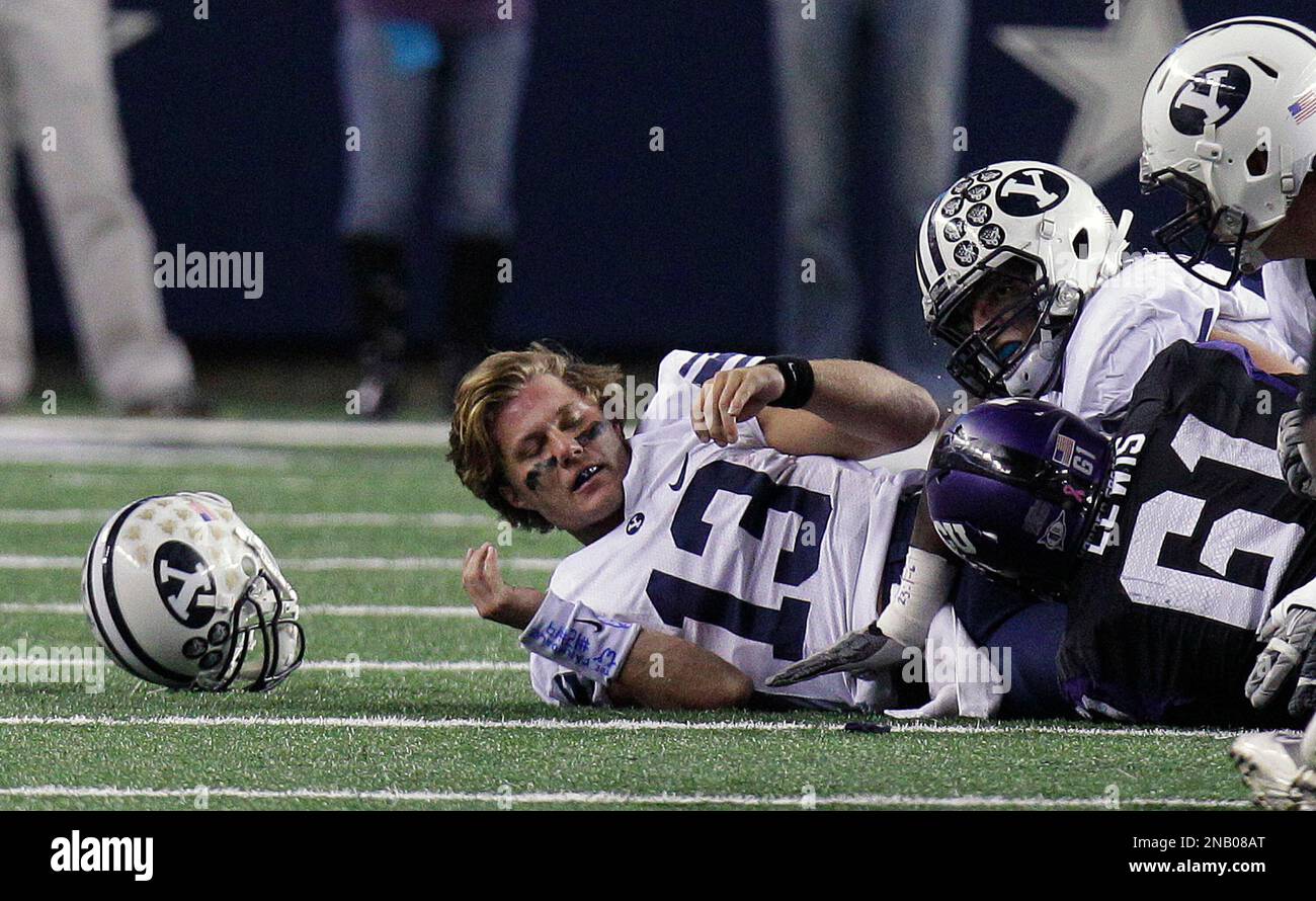 BYU quarterback Riley Nelson (13) looses his helmet on the sack by TCU ...