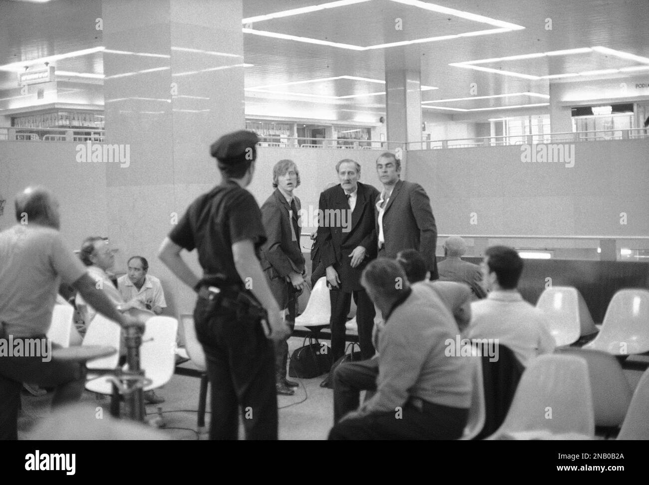 Group of three men during scene in waiting room as they are confronted ...