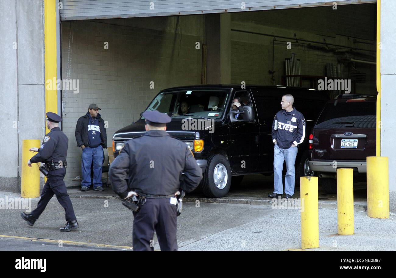 A black NYPD police van delivers some of 17 police officers indicted in ...