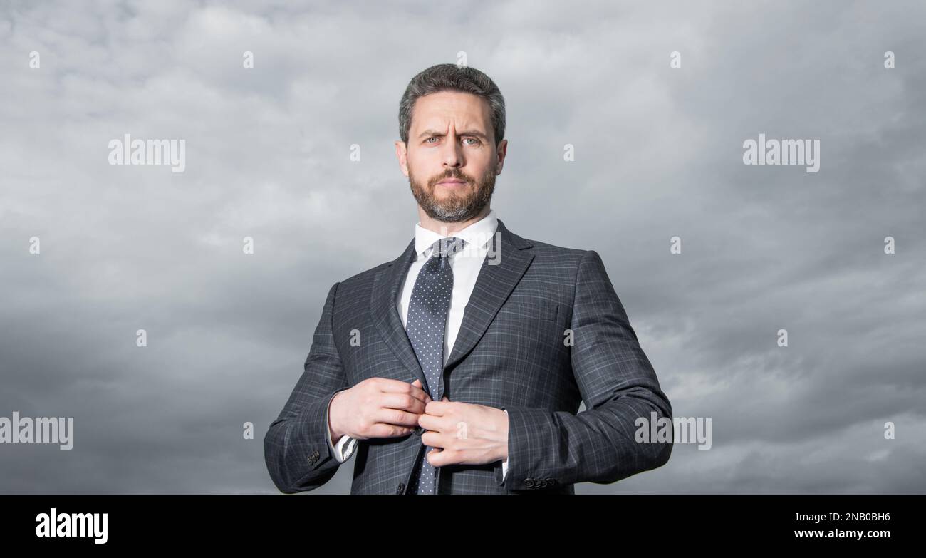 Portrait of man. Professional man buttoning suit. Grizzled man sky ...
