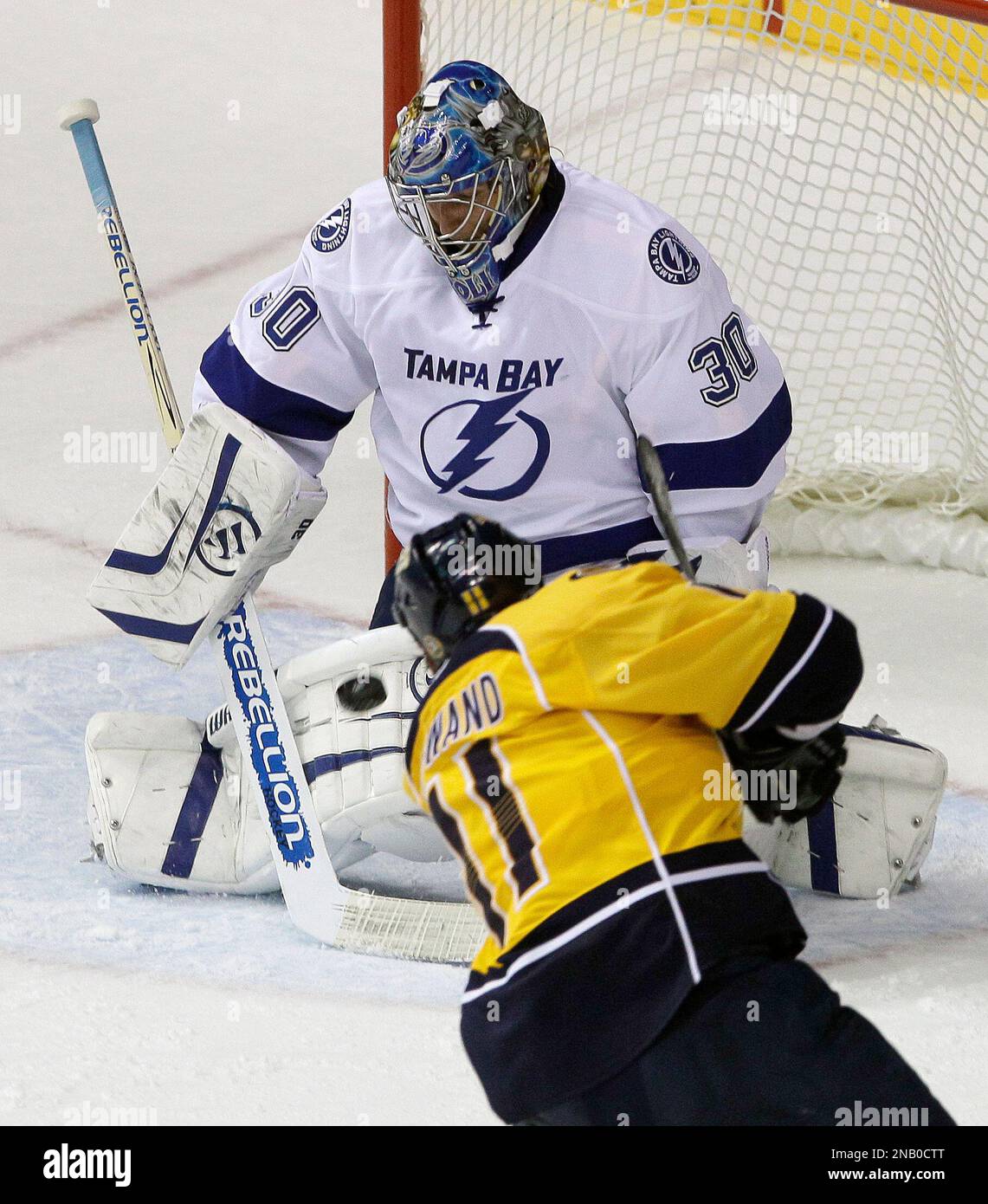 Tampa Bay Lightning goalie Dwayne Roloson (30) blocks a shot by ...
