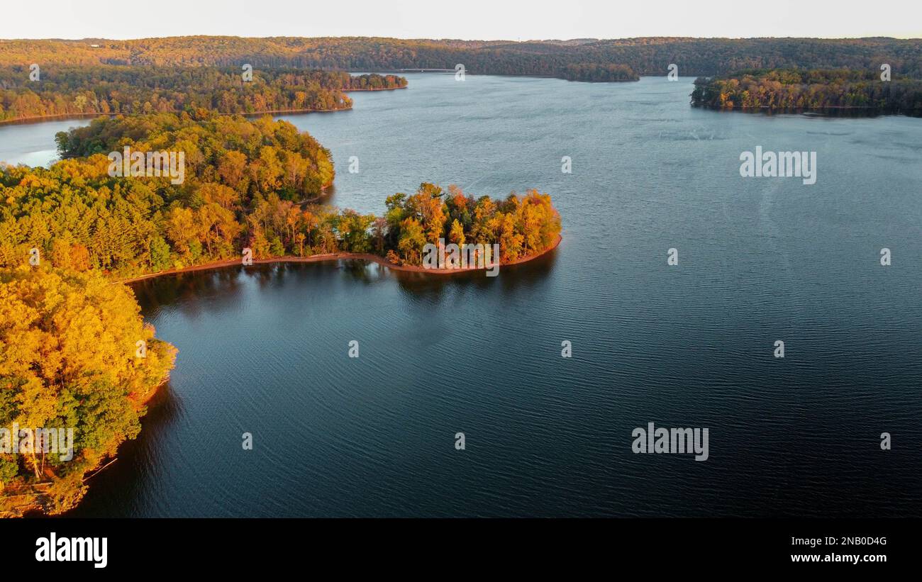 An aerial view of a lush green forest on the shore of Loch Raven Lake ...