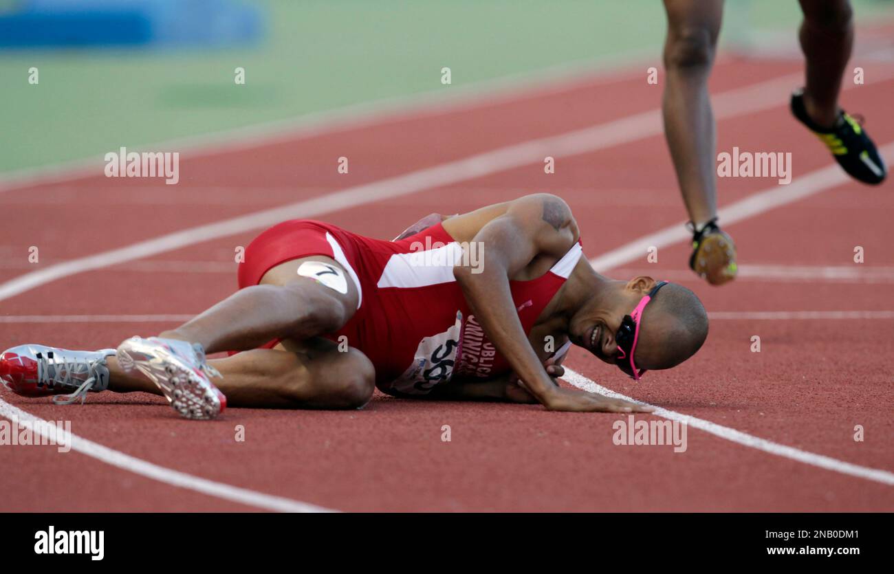 Dominican Republic's Felix Sanchez falls on the track after crossing ...