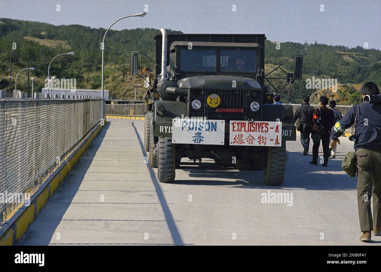 Under military guards, a convoy carrying a first-day load of 150 tons ...