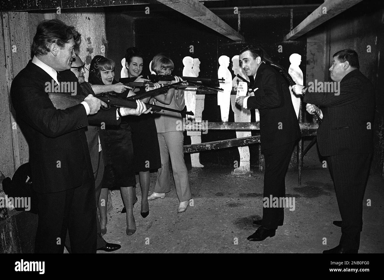 French author Jacques Robert, second from right, holding his newest spy ...