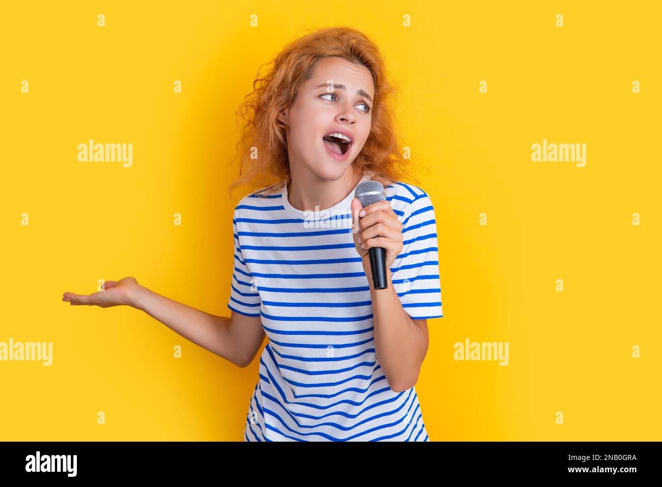 girl singer having fun isolated on yellow background. young singer girl ...