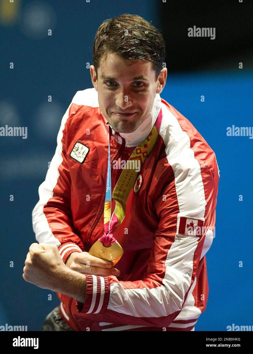 Canada's Philippe Beaudry poses with his gold medal of the men's sabre ...