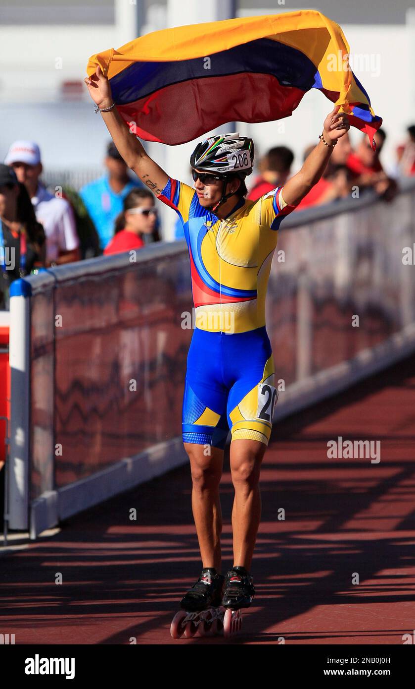 Colombia's Pedro Causil holds his nation's flag as he celebrates ...