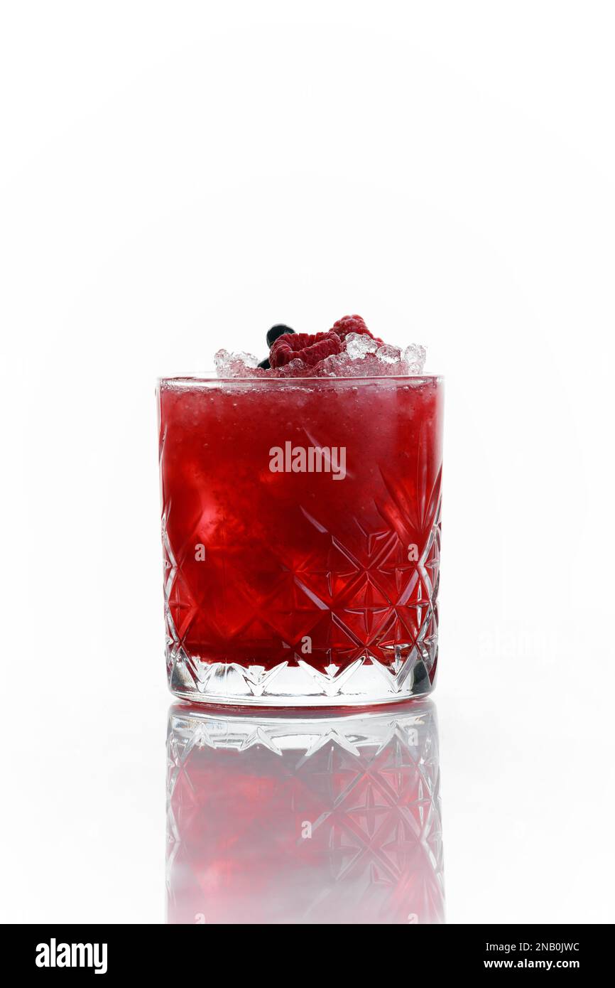 red alcoholic cocktail with berries and frappe in an old fashioned ...