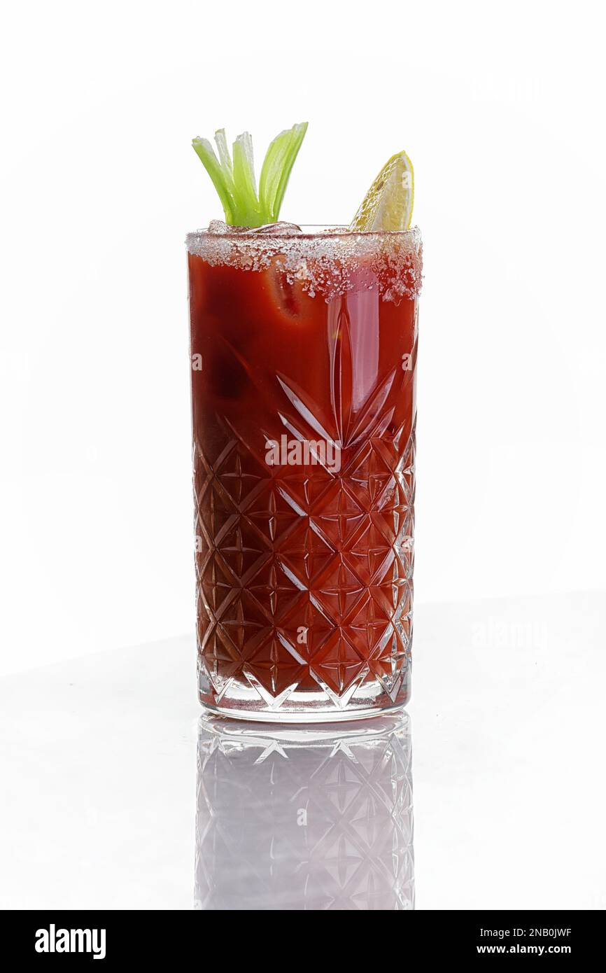Bloody Mary cocktail with a slice of lemon and frappe, on a white ...