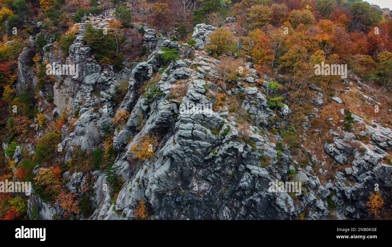 An aerial view of rocky cliffs with autumn trees near Harpers Ferry ...