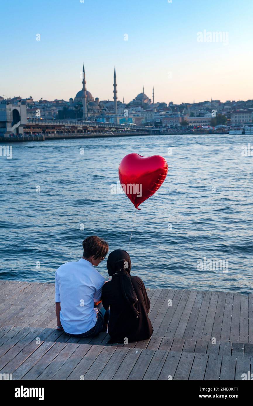 Istanbul, Turkey. 20th October 2019 A romantic couple sit beside the ...