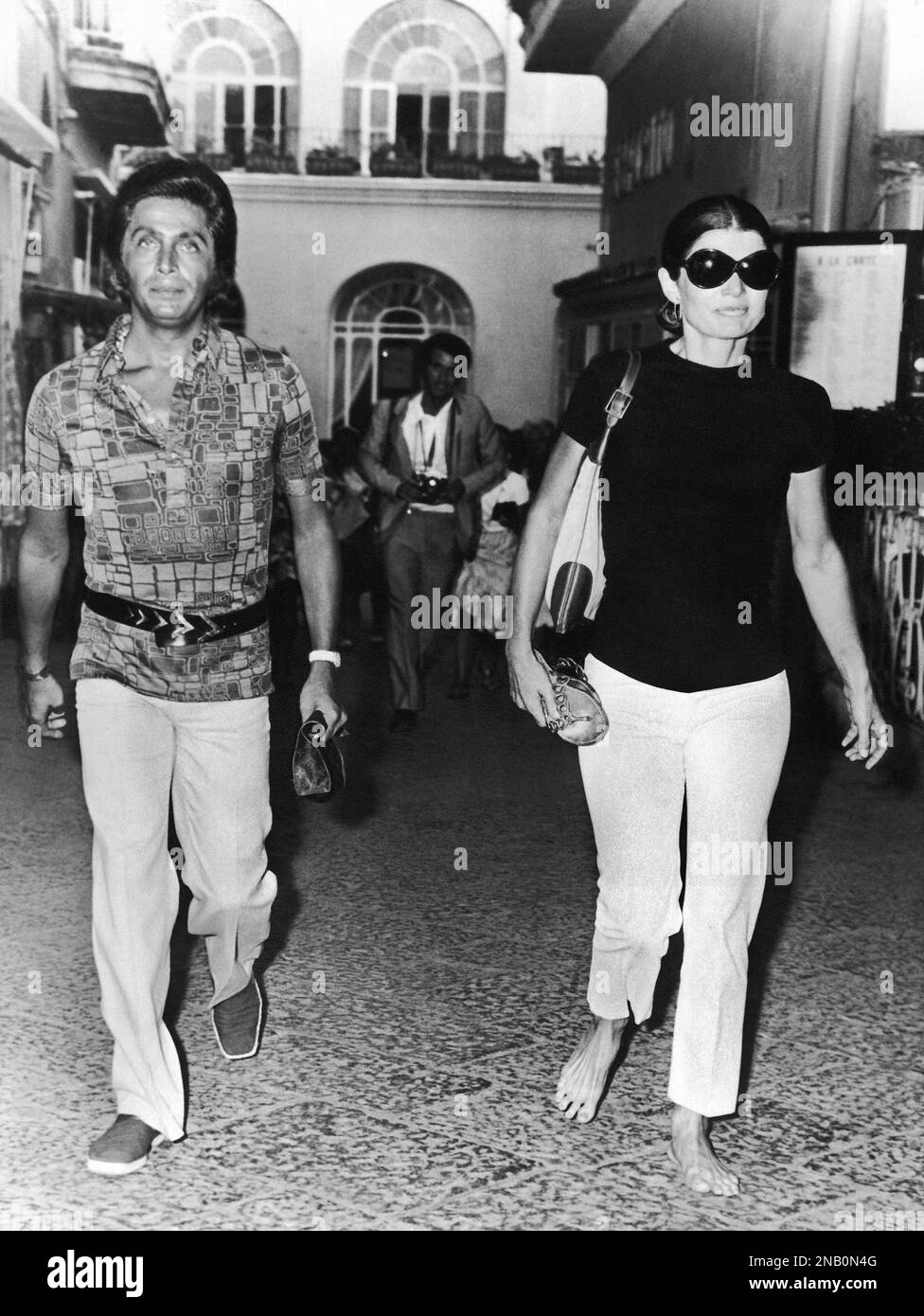 Jacqueline Onassis, walking barefoot, and Italian fashion designer ...