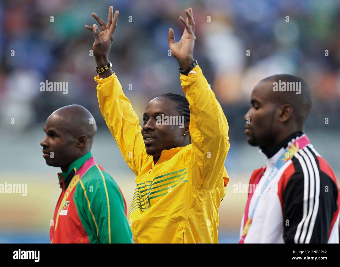 Jamaica's Lerone Clarke center celebrates at the podium after winning ...