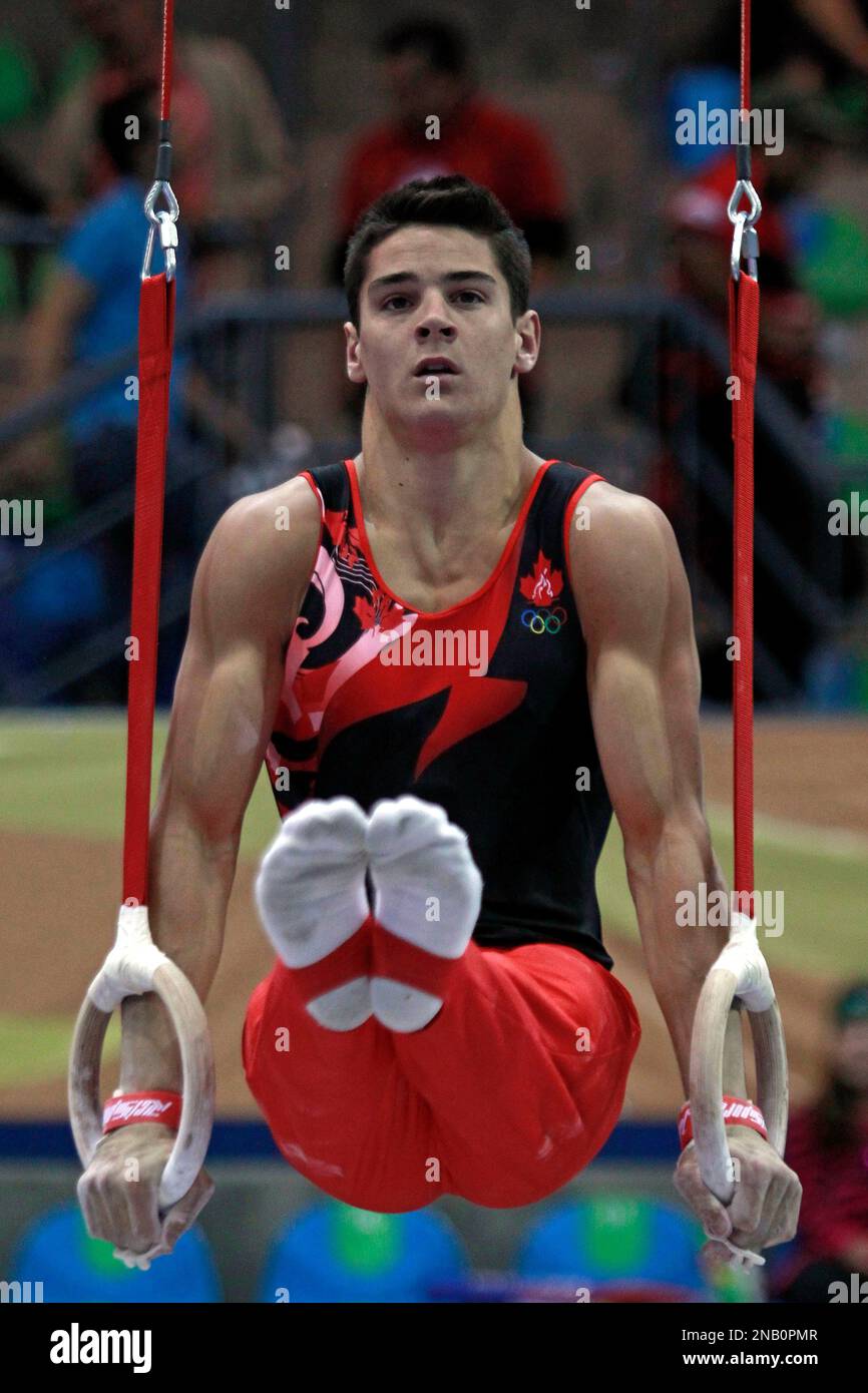 Anderson Loran, of Canada, competes on the still rings during the men's ...