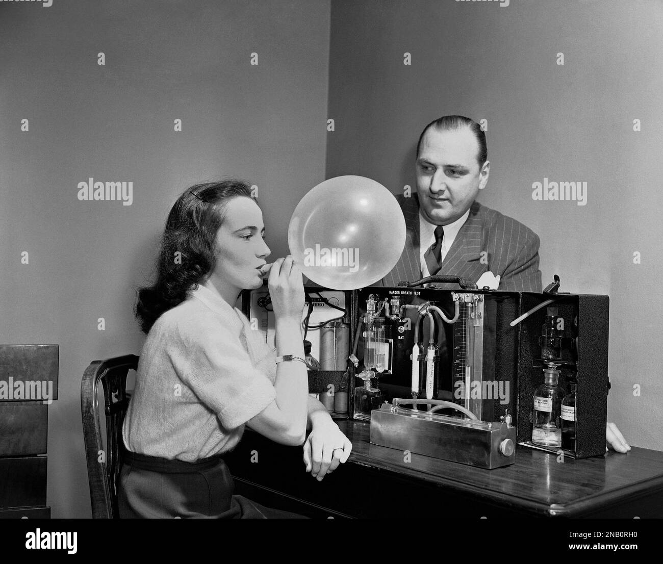Dorothy Brengel helps W.D. Foden, Chairman of Statler Safety Committee ...