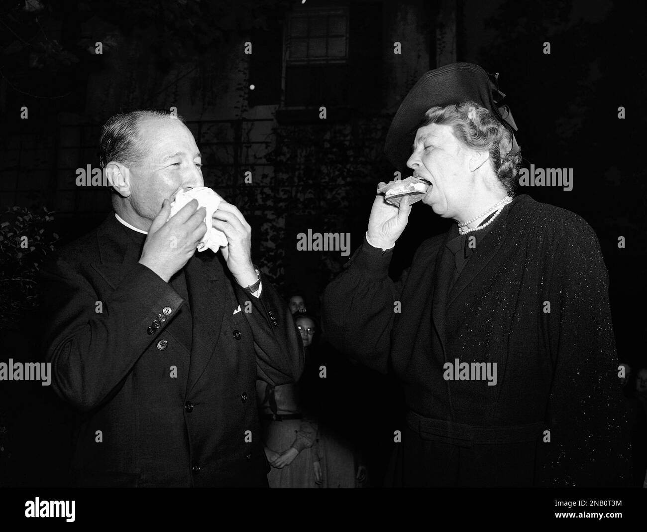 Mrs. Eleanor Roosevelt samples a drum stick of hamburger, corn flakes ...