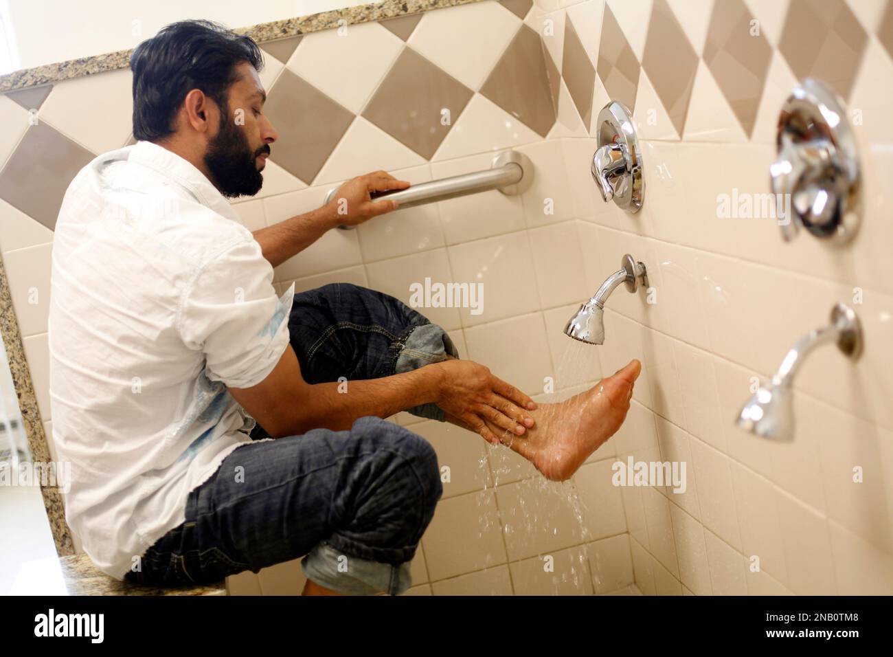 Mohammed Howlader performs ablution before his midday prayers at the ...