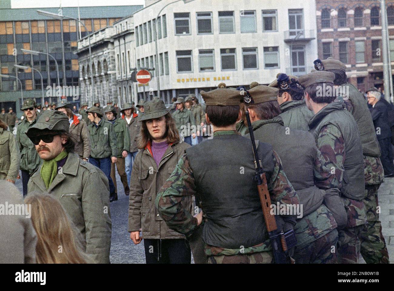 Under the watchful eyes of armed British troops, members of the Ulster ...
